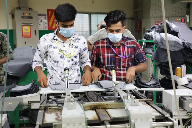 Garment workers safeguard factories from vandalism and keep economic ...